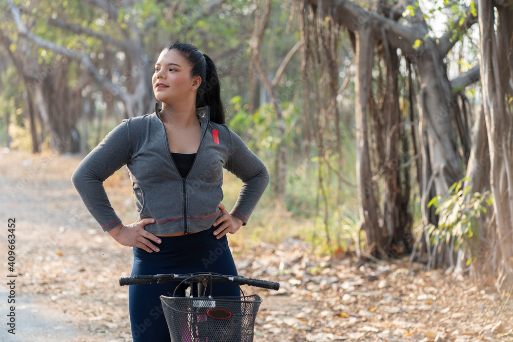 Beautiful shemale wearing sportswear, riding a bicycle, exercising in public beauty in the ...