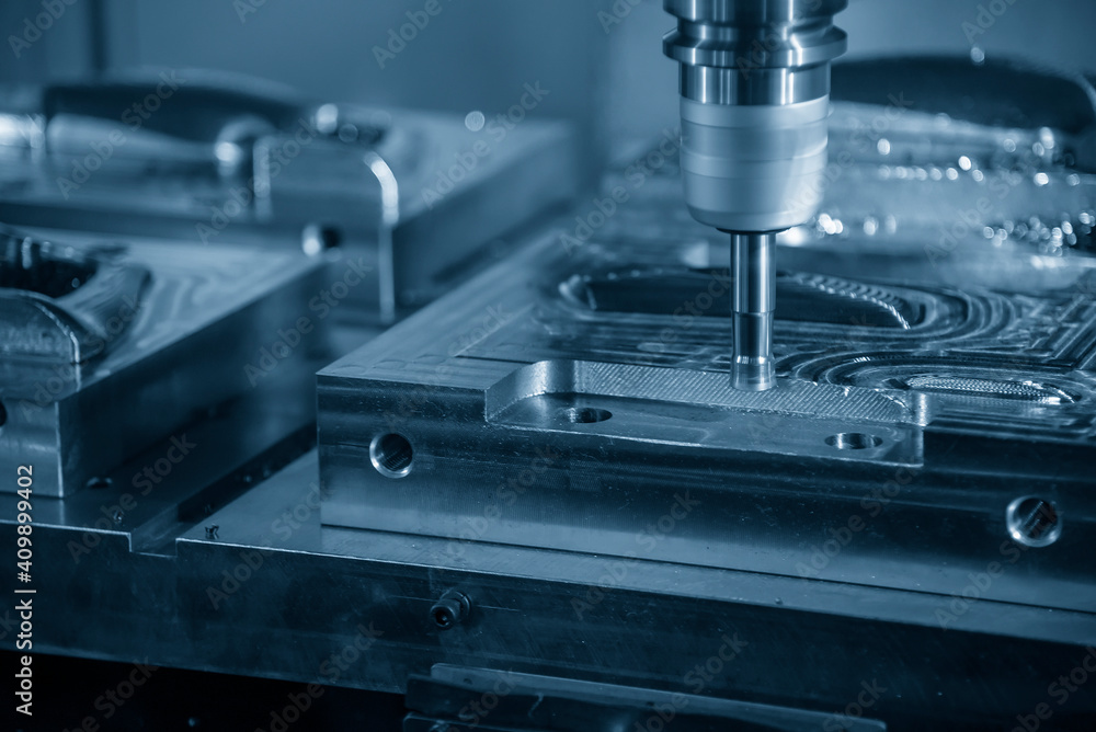The CNC milling machine rough cutting the injection mold parts by ...