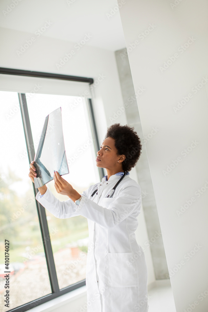 Female African American doctor wearing white coat with stethoscope ...