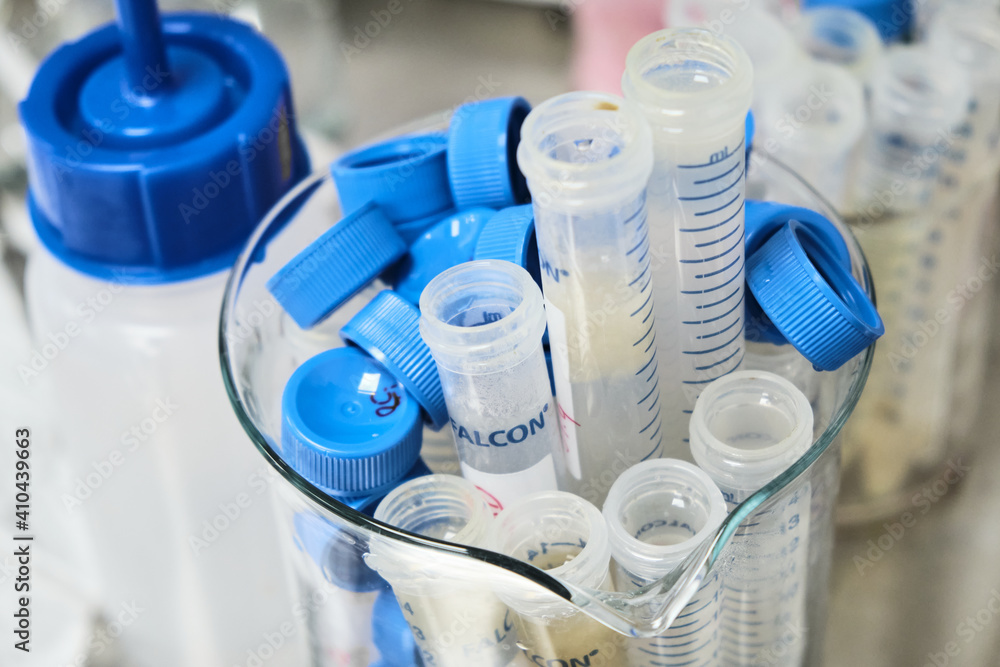 Dirty centrifuge in the beaker after analysis. Falcon tubes with blue ...