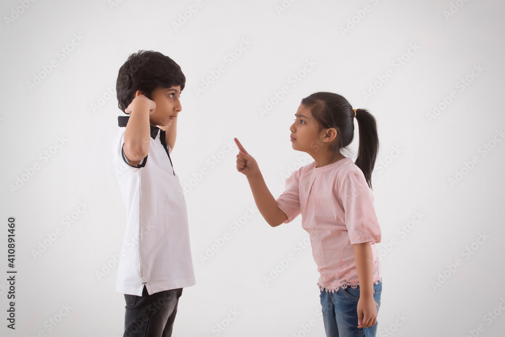 young sister scolding her brother Stock Photo | Adobe Stock
