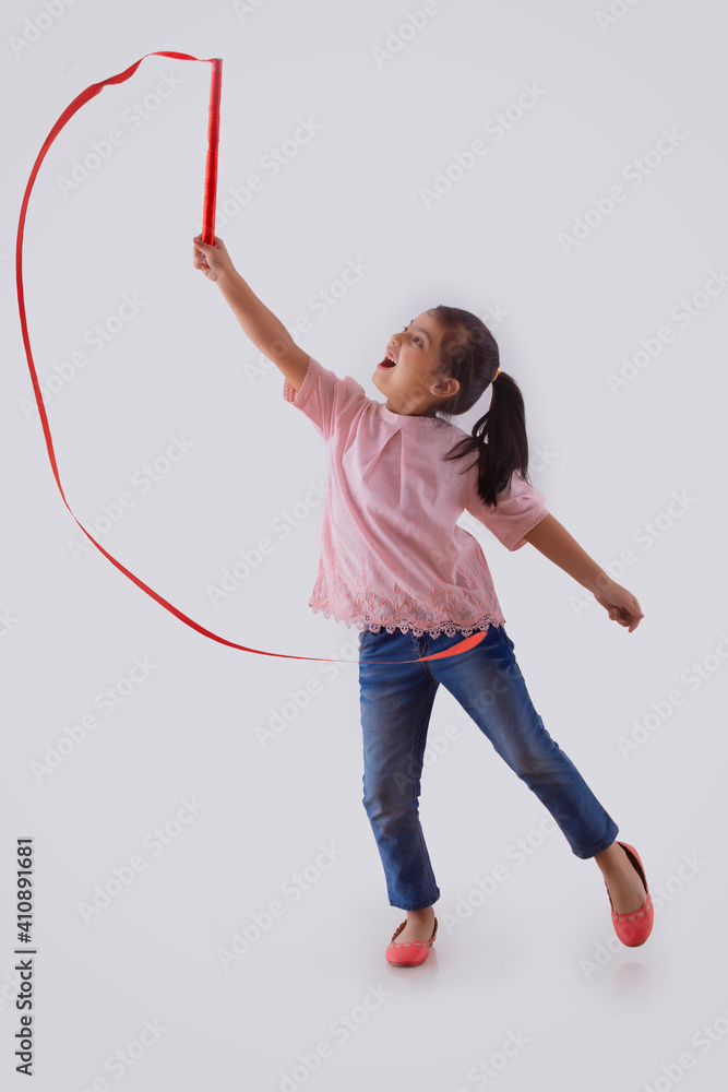 young girl playing with a ribbon wand Stock Photo | Adobe Stock