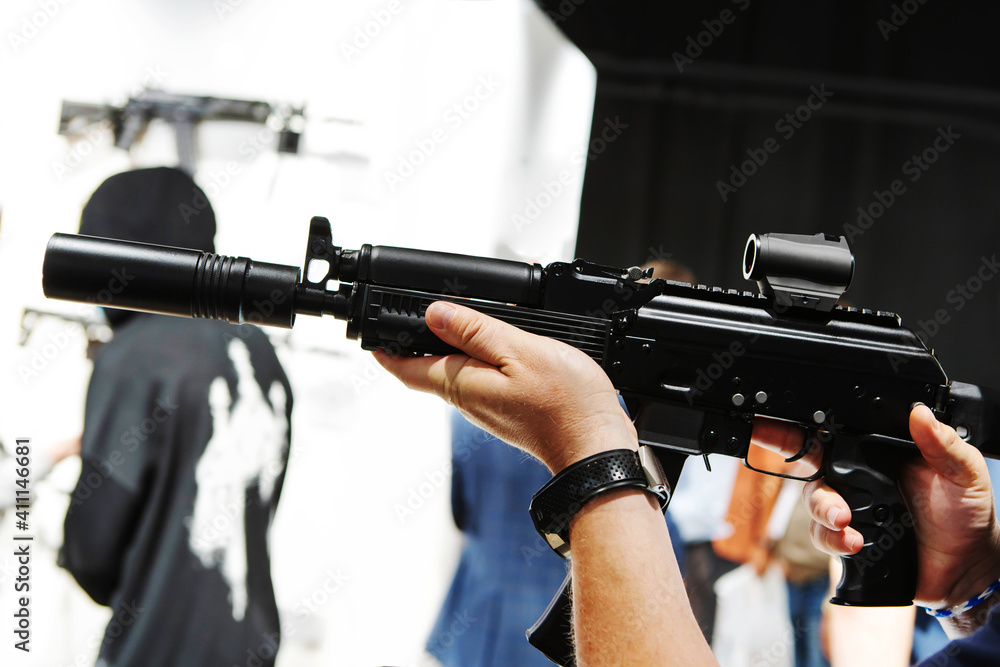 Firearms. Automatic machine gun with a silencer and an optical sight in ...