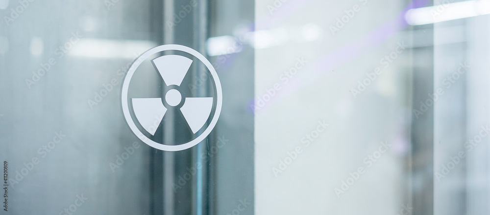 Radiation zone sign sticker on window of laboratory room. Health and ...