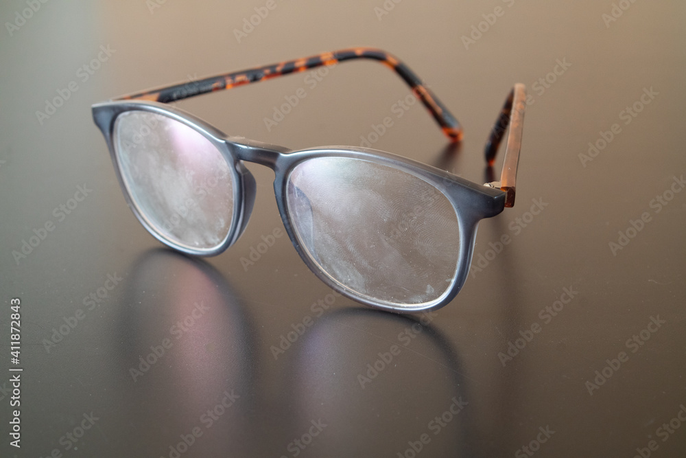 Eyeglasses with fingerprints over the lenses, smudged finger marks ...