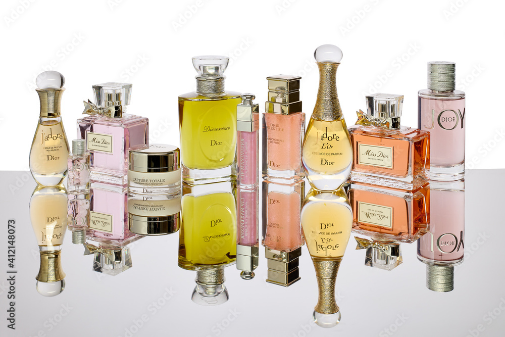 Collection of perfumes and cosmetic products from Dior on white ...