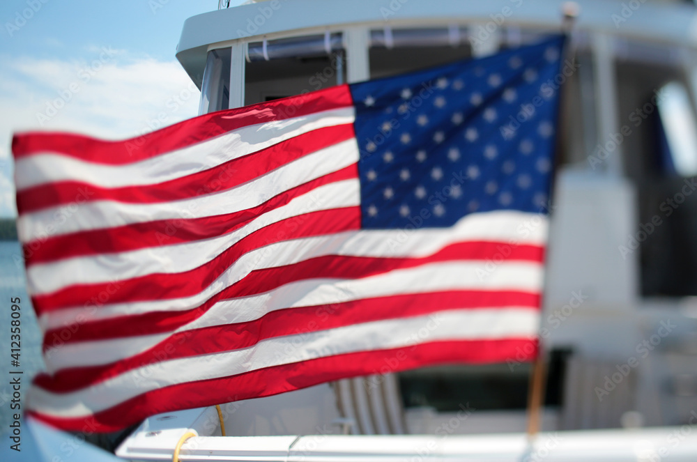 American Flag Flying On The Back Of A Boat Stock Photo | Adobe Stock