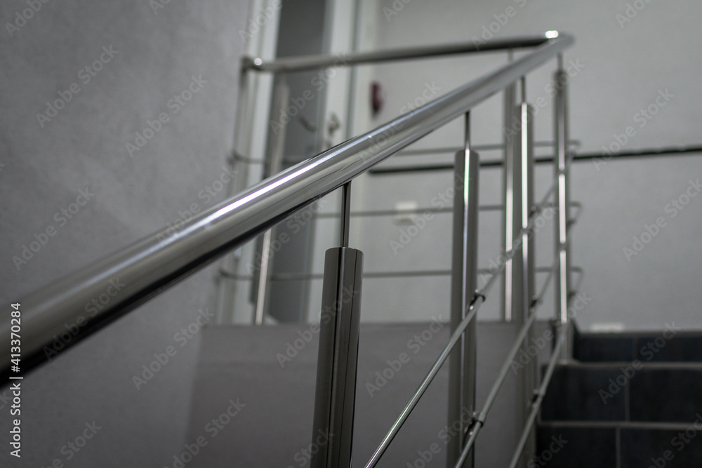 Stainless steel handrails of a new office premise, selective focus ...
