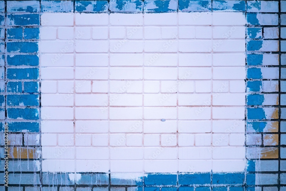 Brick wall painted blue with a pinky white square in the center Stock ...