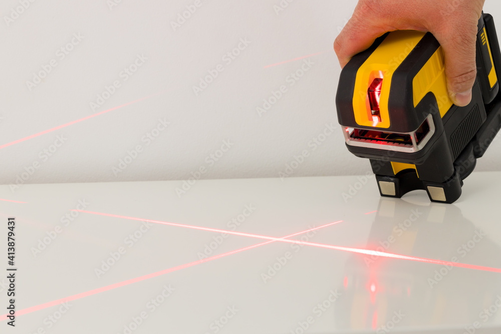Electronic laser pointing straight lines. Checking angles and setting ...