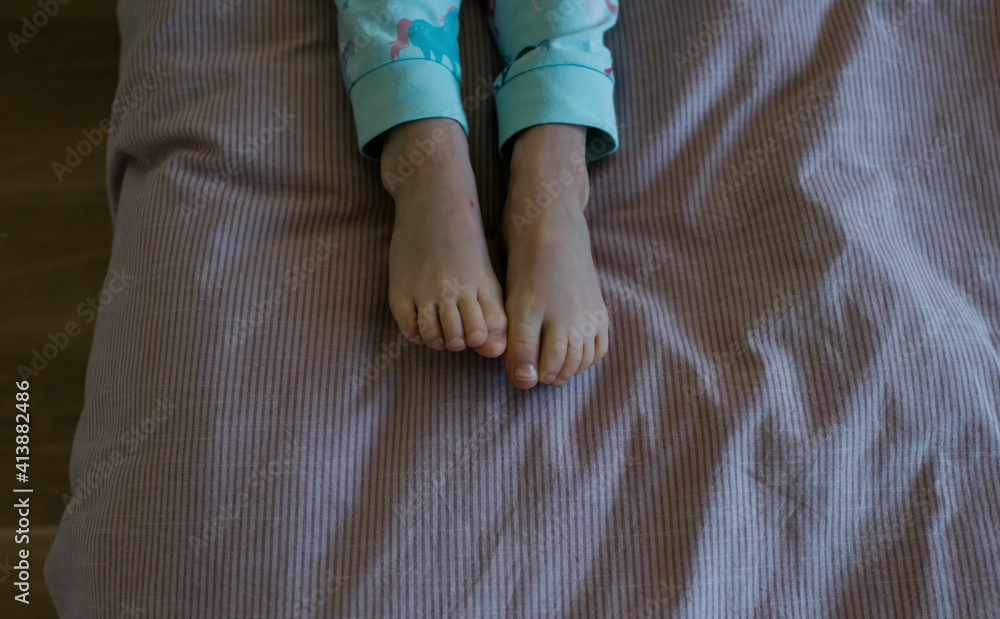 young Child's feet pointing their toes on a bed Stock Photo | Adobe Stock