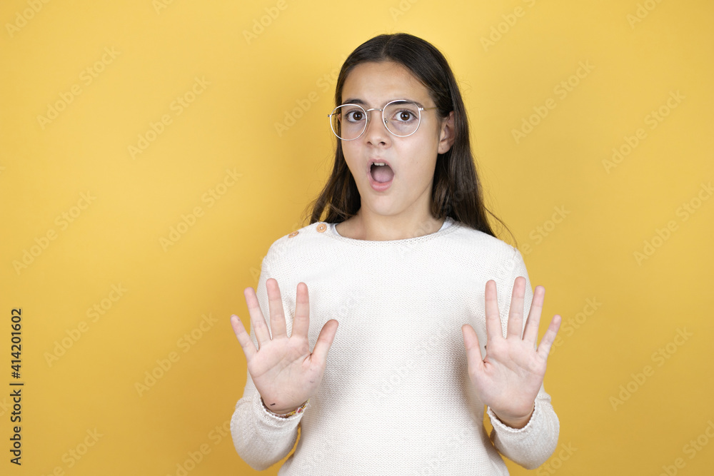 Beautiful child girl wearing casual clothes afraid and terrified with ...