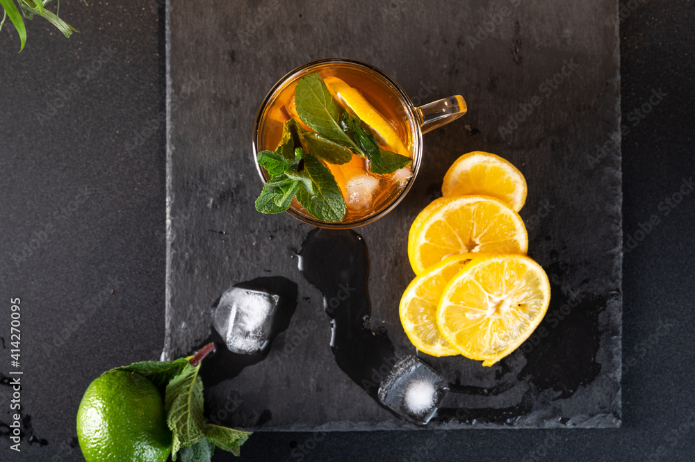 Iced tea with lemon. Mint leaves and melted ice cubes. Stock Photo ...