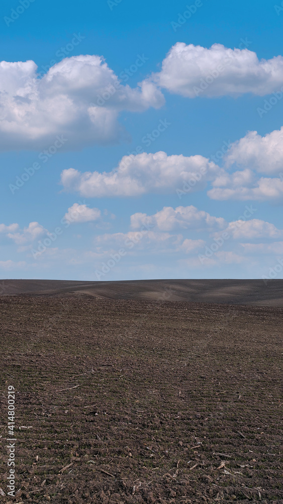 Empty plowed field under blue sky. Minimalistic and clean farming land ...