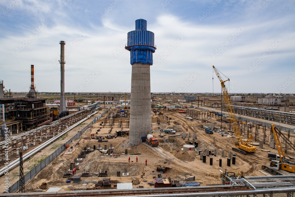 Construction of new concrete smoke stack (plant chimney). Panorama of ...
