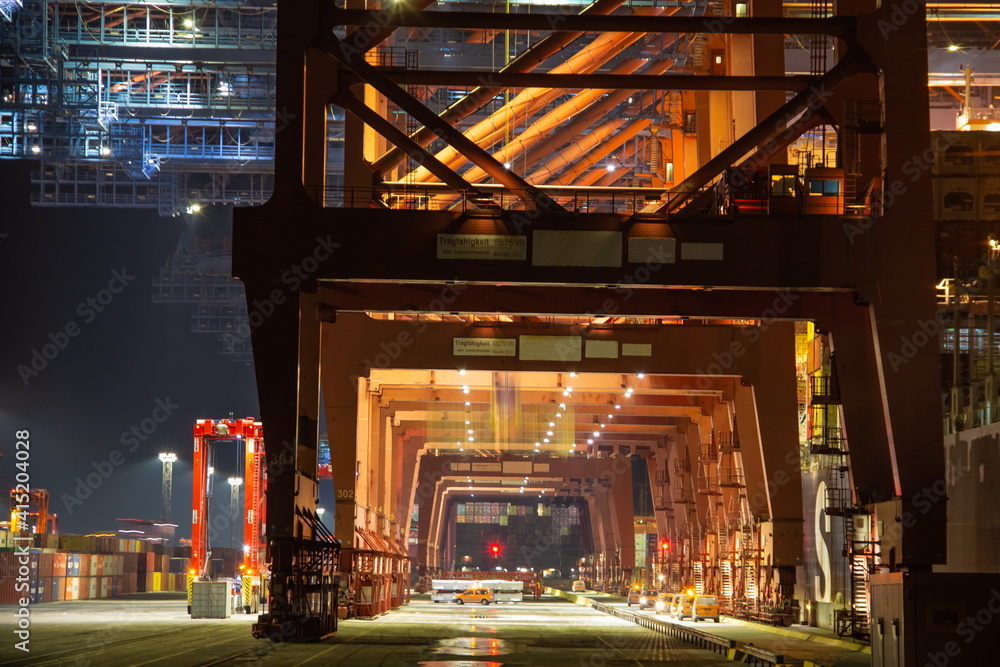 Cranes and vehicles in the container harbour port during logistic ...