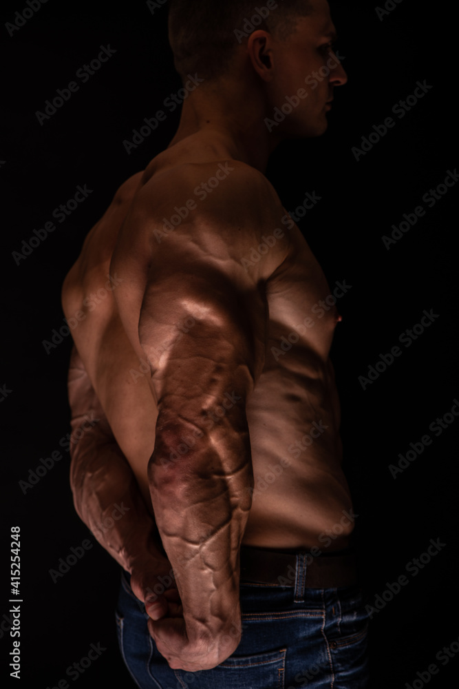 Muscled male model flexing triceps Stock Photo | Adobe Stock