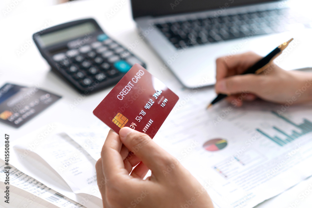 Asian woman checking bills, taxes, bank account balance and calculating ...