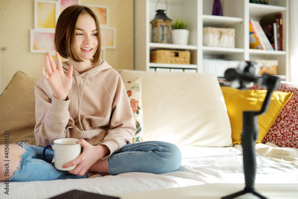 Beautiful teenage girl recording video blog with her smartphone. Young ...