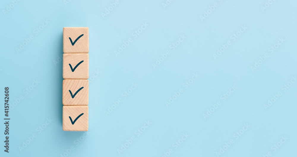 Checklist concept, Check mark on wooden blocks, blue background with ...