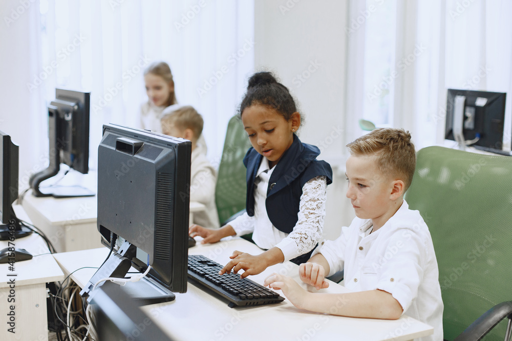Guy and the girl are sitting at the table. African girl in computer ...