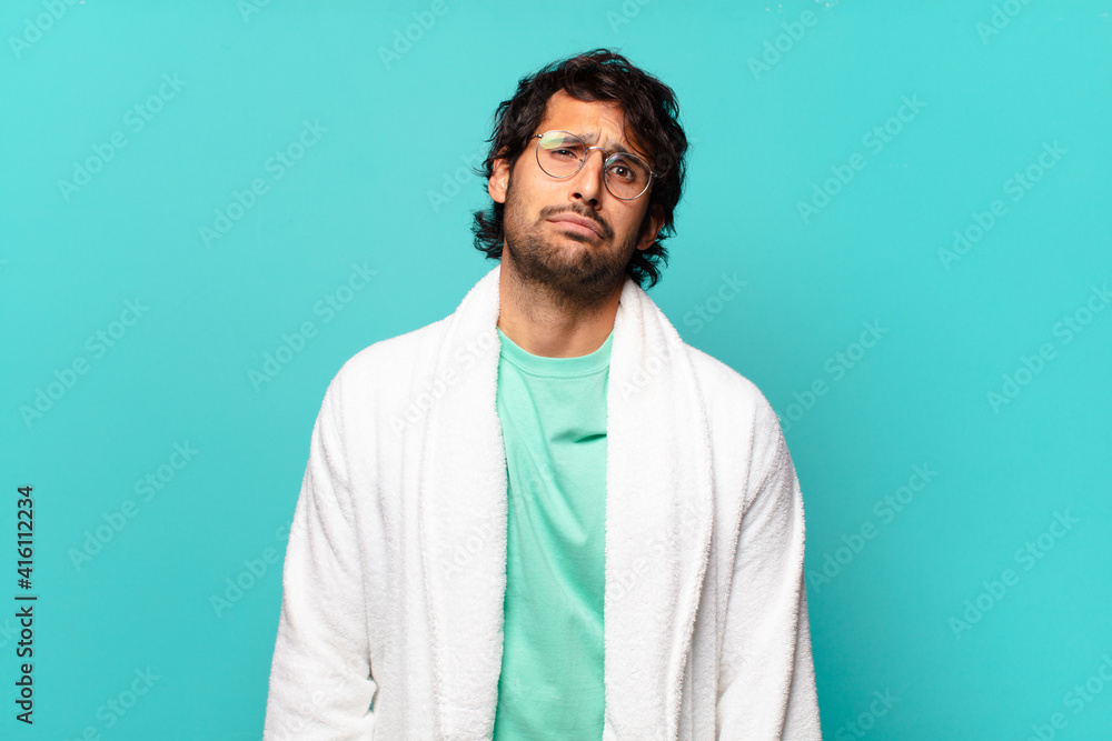 young handsome indian man feeling sad and whiney with an unhappy look ...