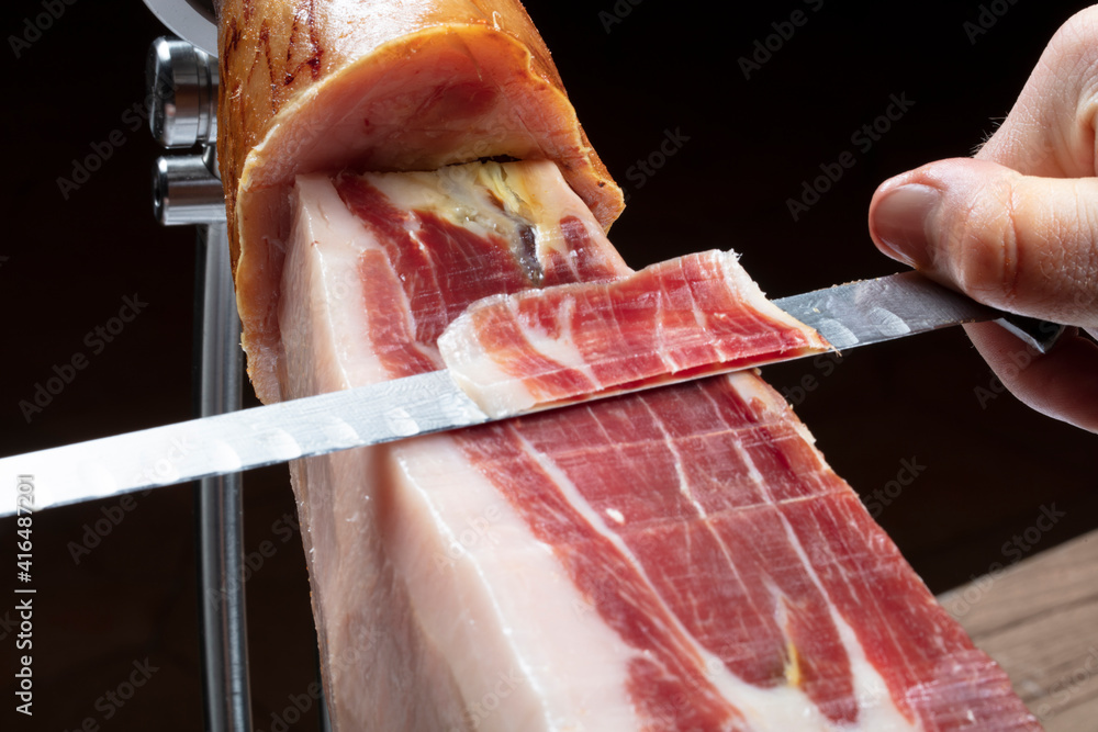 corte de jamón iberico de bellota, mano cortando jamón. acorn-fed ...