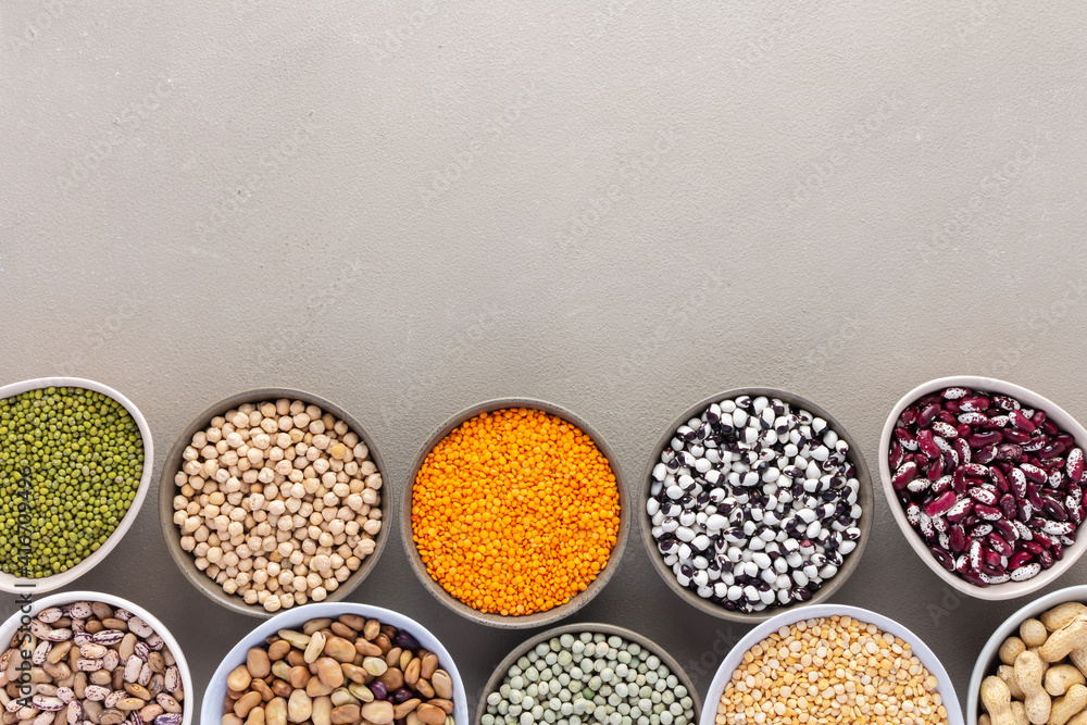 Different types of legumes in bowls, green and yellow peas, chickpeas ...