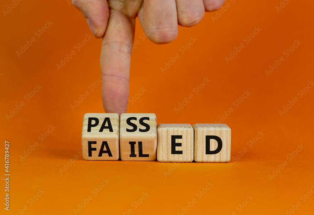 Passed or failed symbol. Businessman turns wooden cubes and changes the ...