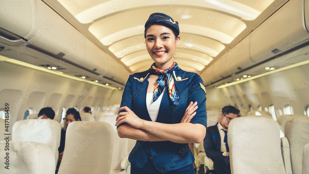 Cabin crew or air hostess working in airplane . Airline transportation ...