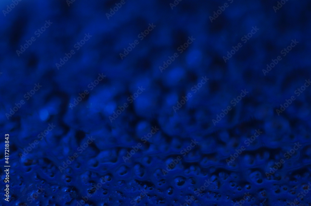 Abstract blue mysterious background. Rough texture in dark light. Oily ...