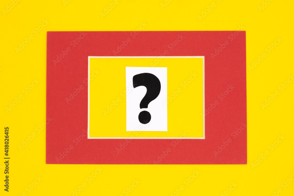 a question mark on a white sheet in the frame . FAQ frequency asked ...