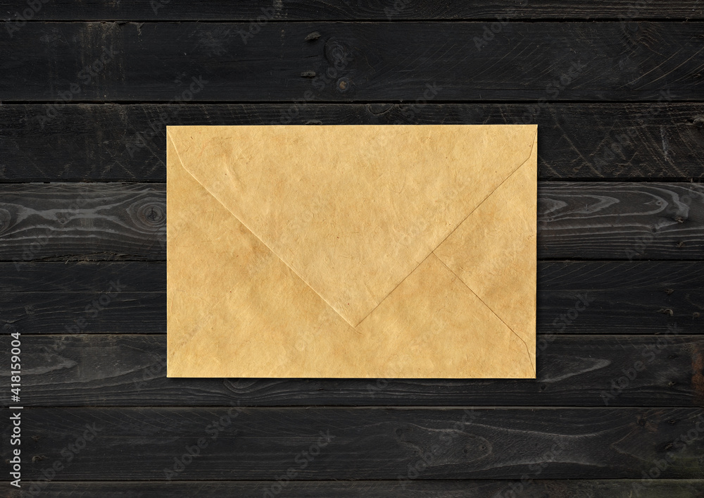 Brown paper enveloppe mockup template on black wood background Stock ...