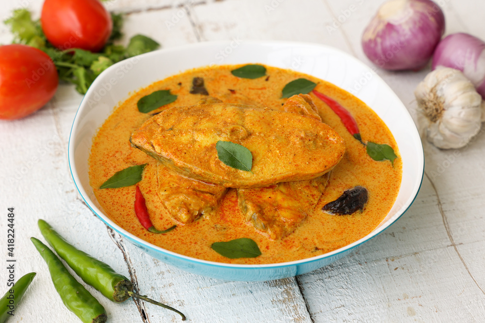 Kerala fish curry coconut milk gravy , cooking spicy Goan fish curry ...