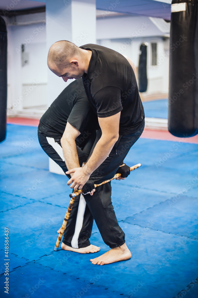 Instructor and student practice filipino escrima stick fighting ...