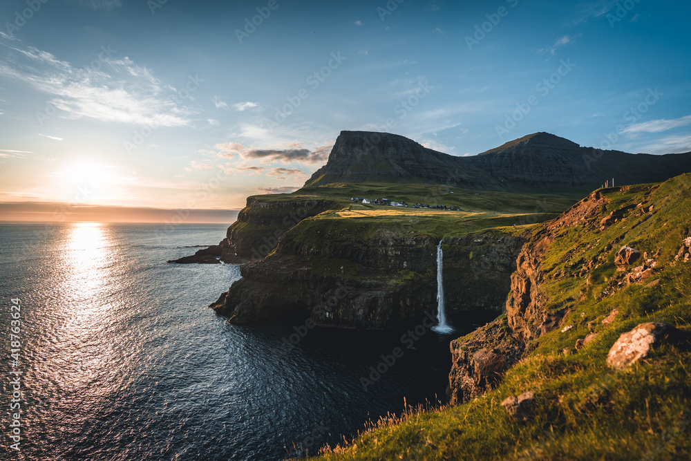 Gasadalur village and Mulafossur its iconic waterfall during summer ...