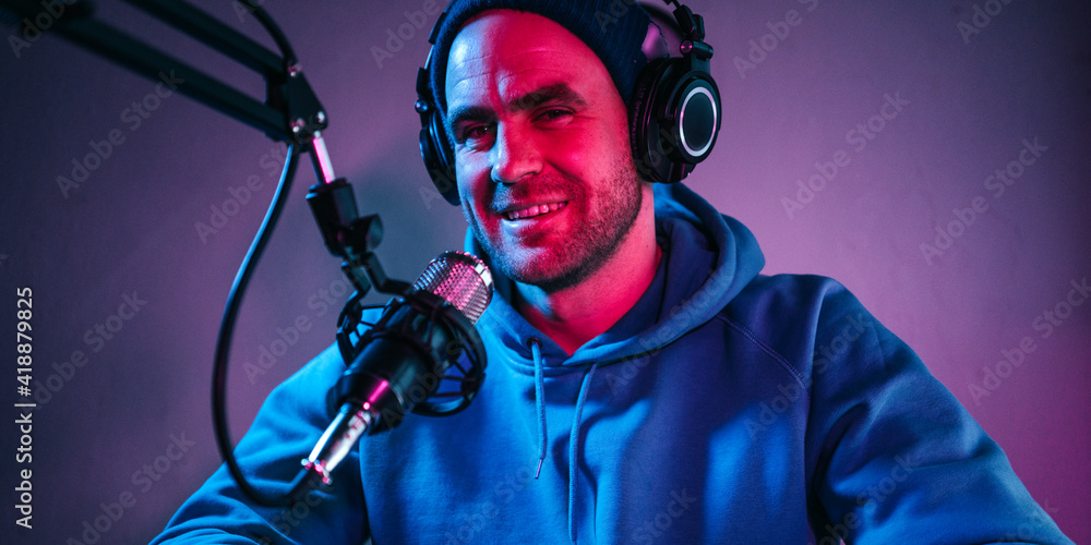 Portrait of streamer broadcasting his audio show at home studio using ...