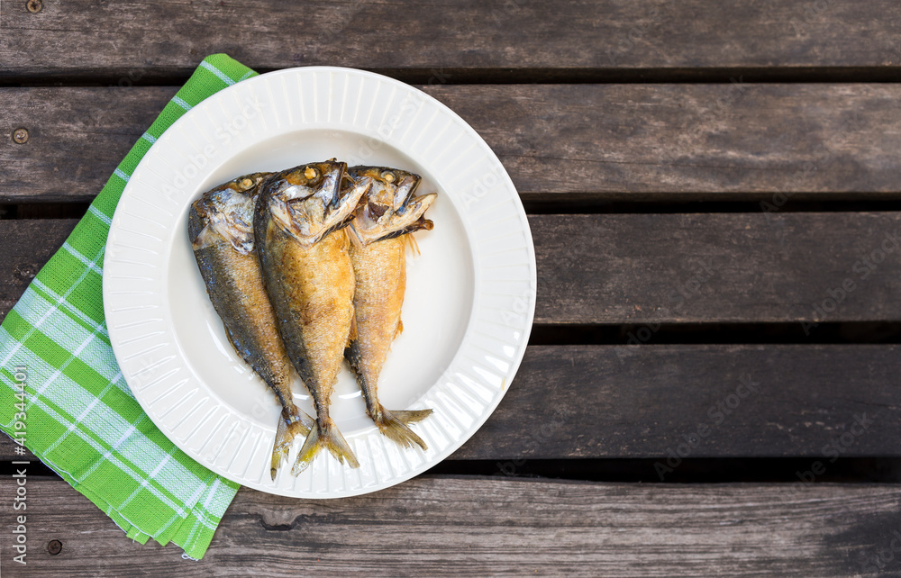 Crispy deep fried mackerel fish on on old wooden floor texture ...