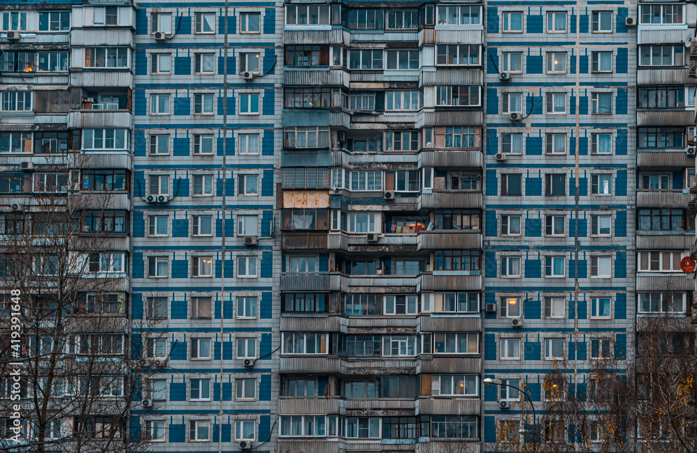 Old facades of brutalist soviet socialist buildings. The gloomy windows ...