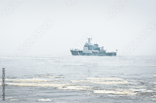 Coast guard ship sailing during the storm. Winter. Fog, waves, rough ...