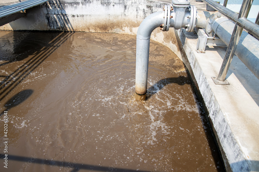 Sewage from drainpipe factory flowing to water treatment tank of waste ...
