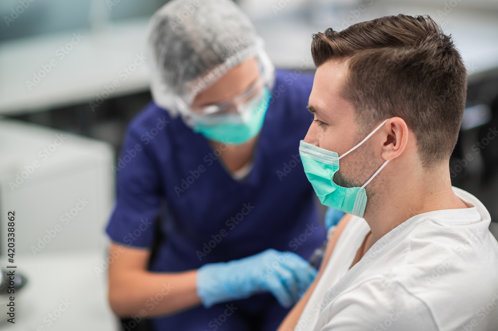 In the laboratory at the hospital, a nurse gives an injection into the ...