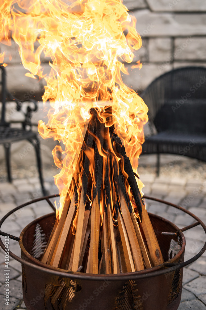 Lighting of a backyard bonfire Stock Photo | Adobe Stock
