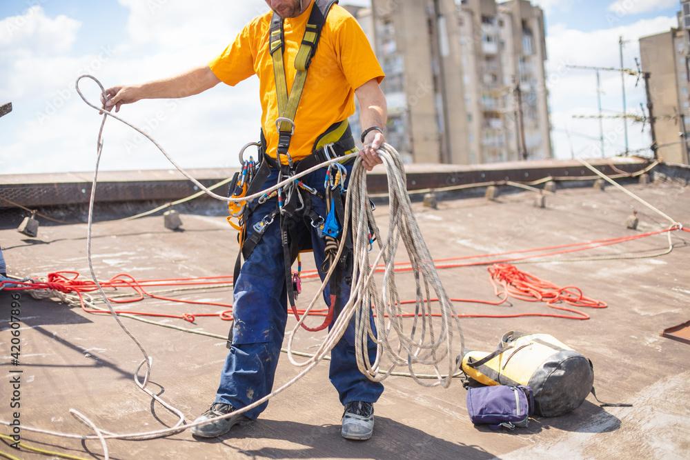 Working at elevations. Rope access, high-altitude outdoor work. Stock ...