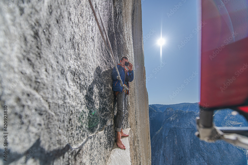 Mountaineer climbing up sheer wall of The Nose, El Capitan, Yosemite ...