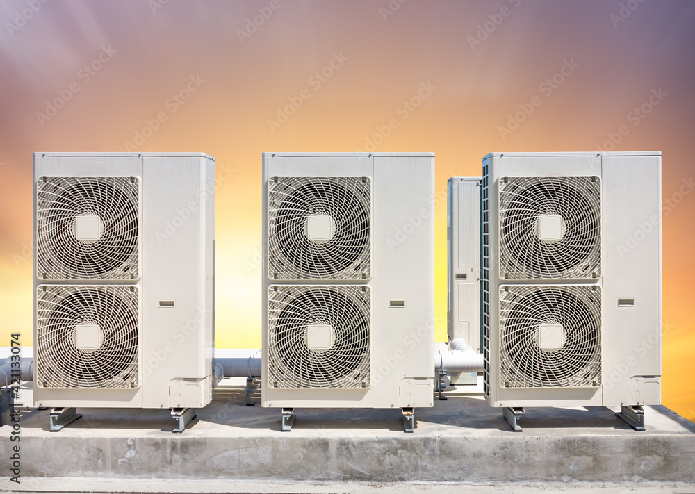 Condenser unit or compressor on roof of industrial plant building with ...