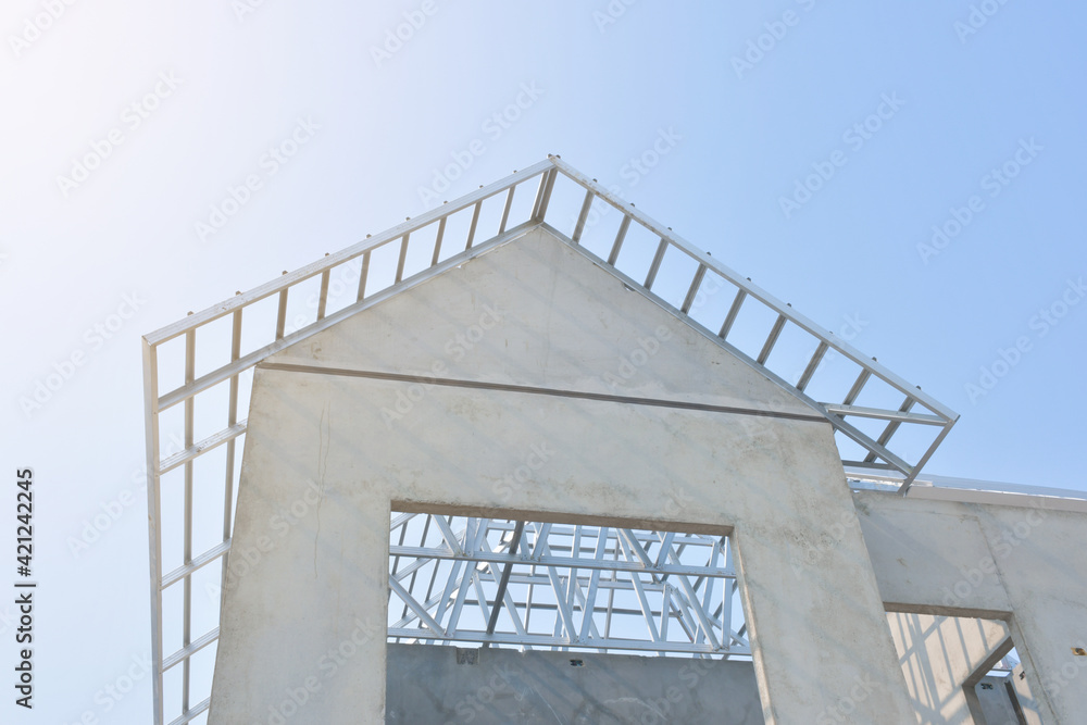 The house, while construction, is installing a steel roof frame using ...