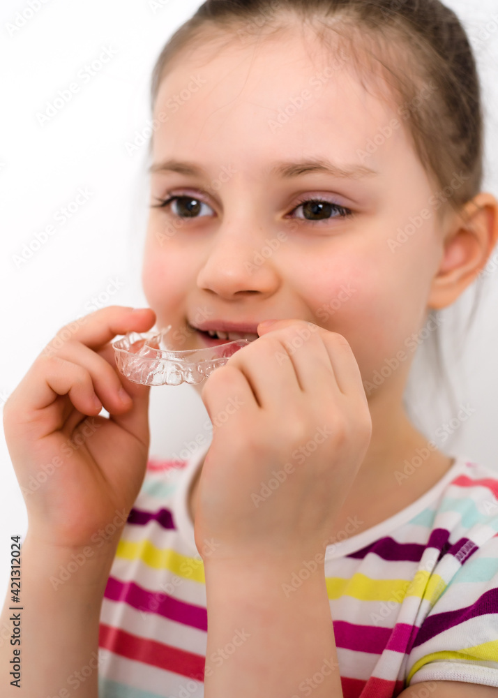 Little girl is holding invisible aligner orthodontic and braces. Stock ...