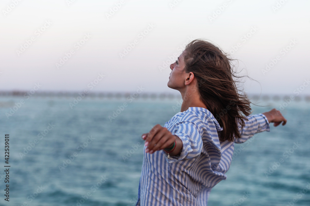 Woman enjoying freedom. Standing arms outstretched back and enjoy life ...
