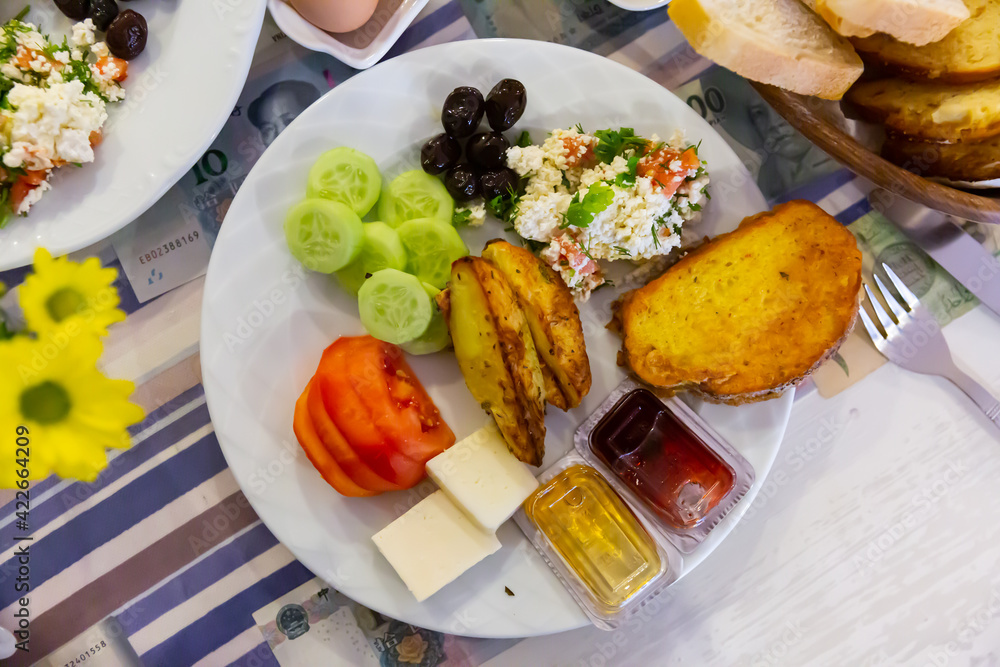 Platter with halal breakfast in Turkish hotel - baked potato slices ...